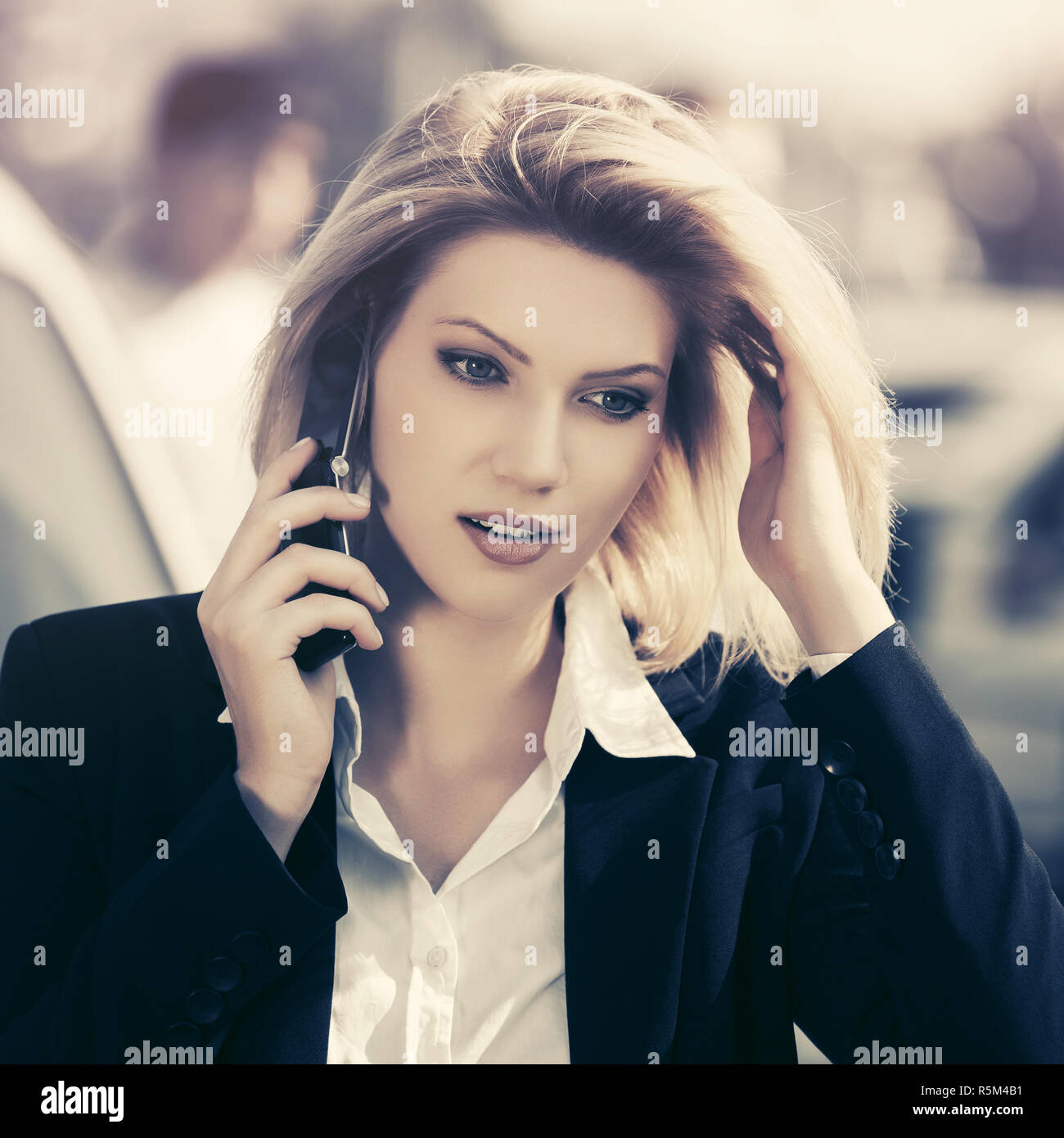 Young fashion business woman calling on cell phone in city street ...