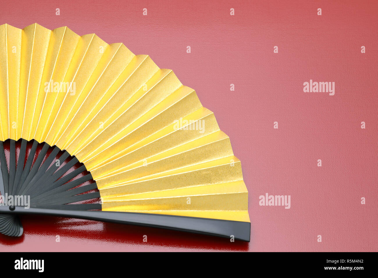 traditional golden folding fan Stock Photo - Alamy