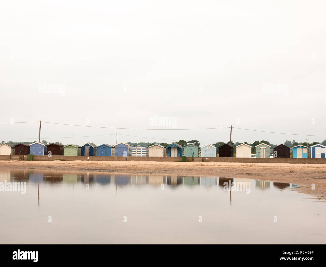 beautiful scene of beach huts with reflections in water in front Stock ...