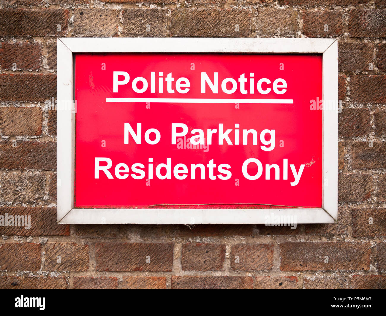 close up of red placard sign outside houses no parking residents only ...