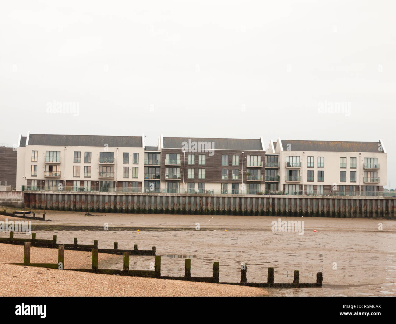 modern contemporary flats with sea front groynes Stock Photo - Alamy