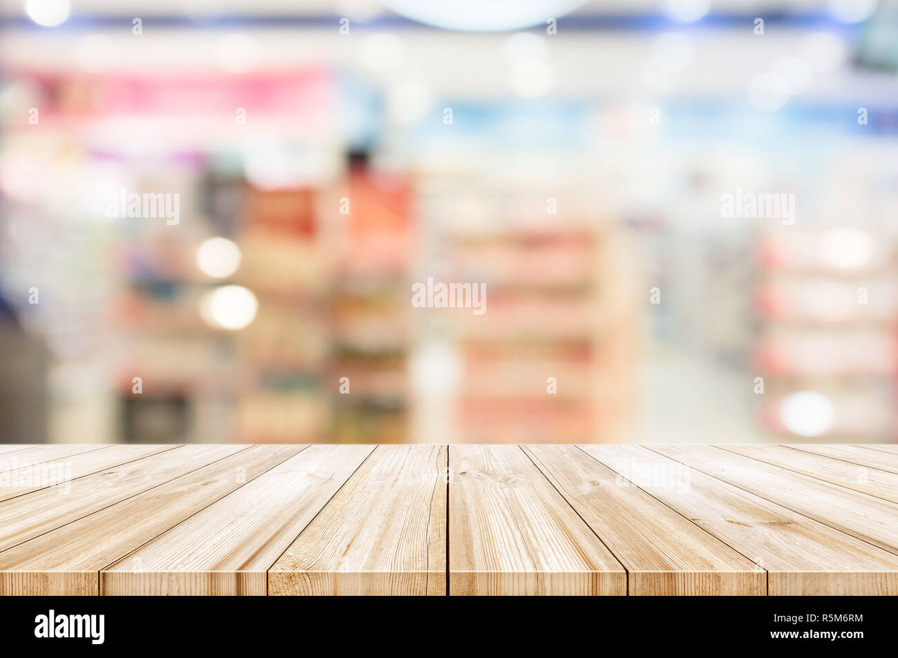 Empty wooden table top with blurred modern shopping mall background ...