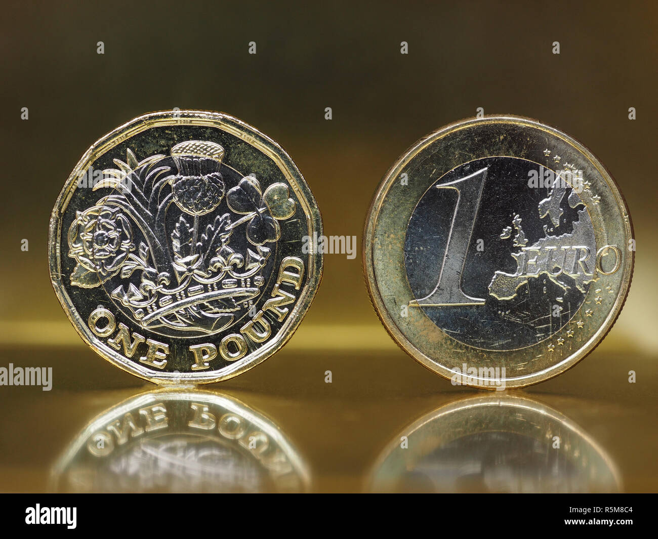 1 pound and 1 euro coin over metal background Stock Photo - Alamy