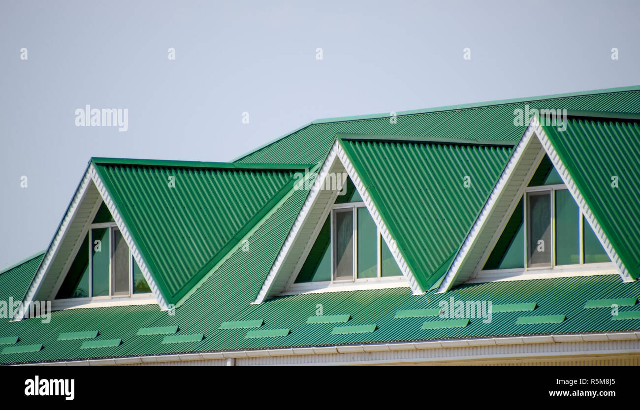 The house with plastic windows and a green roof of corrugated sheet ...