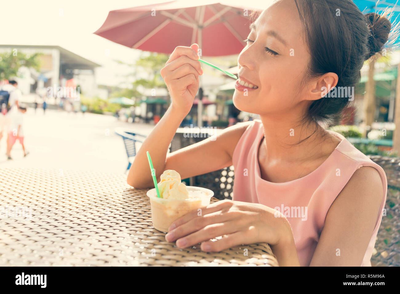 Woman enjoy iced cream at outdoor city Stock Photo - Alamy