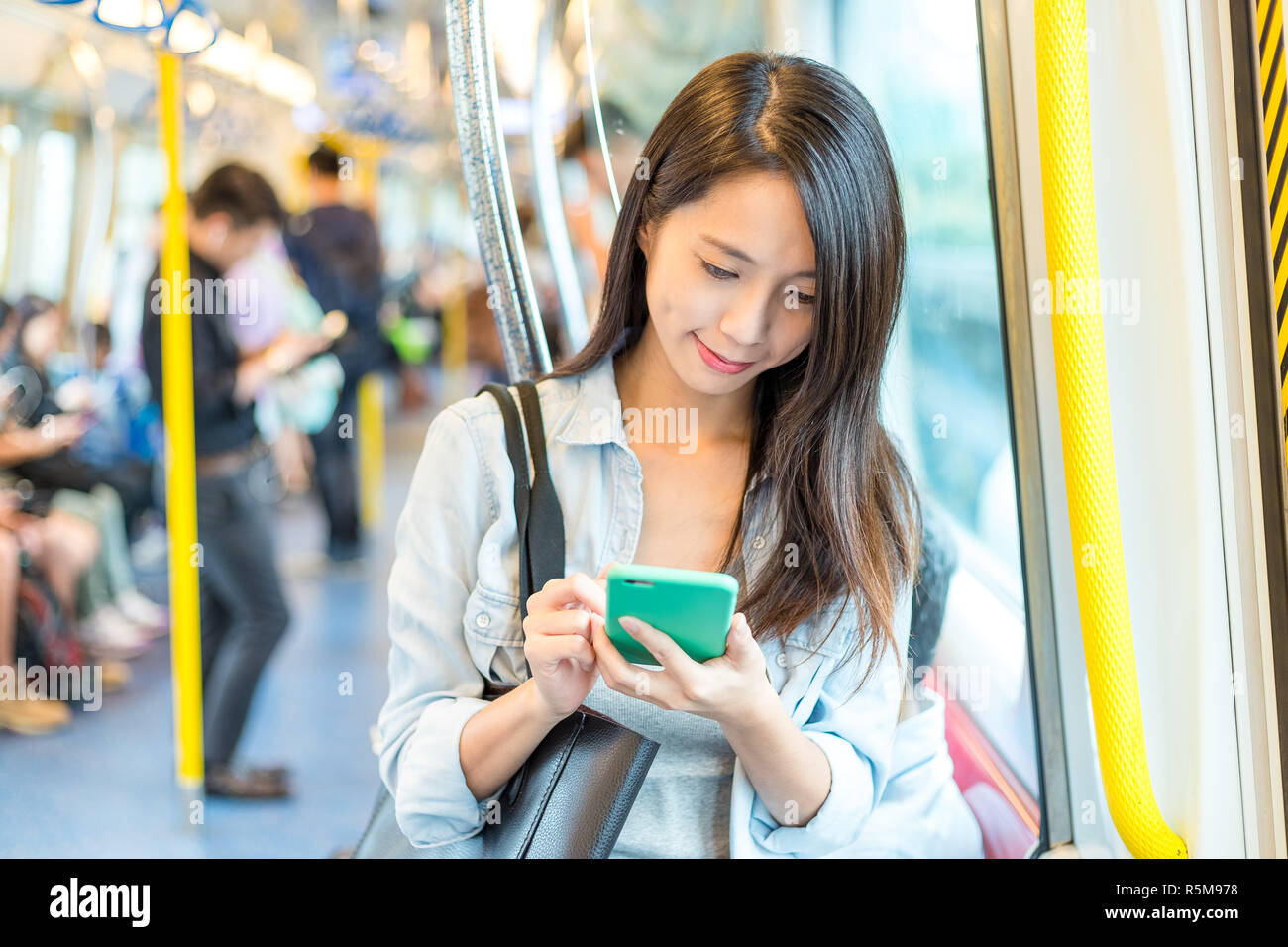 Woman use of cellphone inside train compartment Stock Photo - Alamy