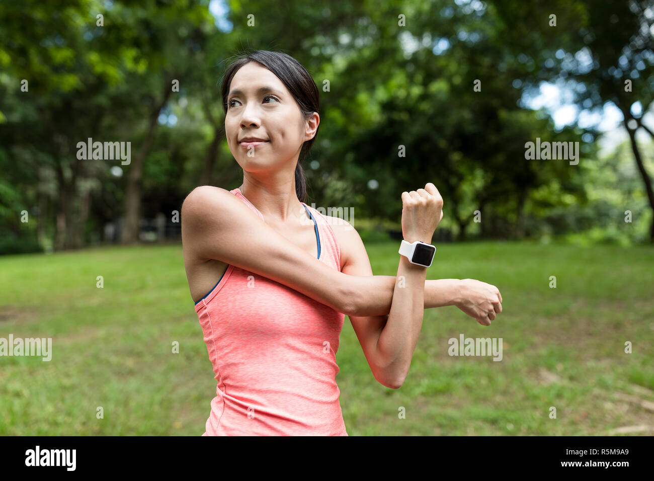Sport woman stretching arm Stock Photo - Alamy