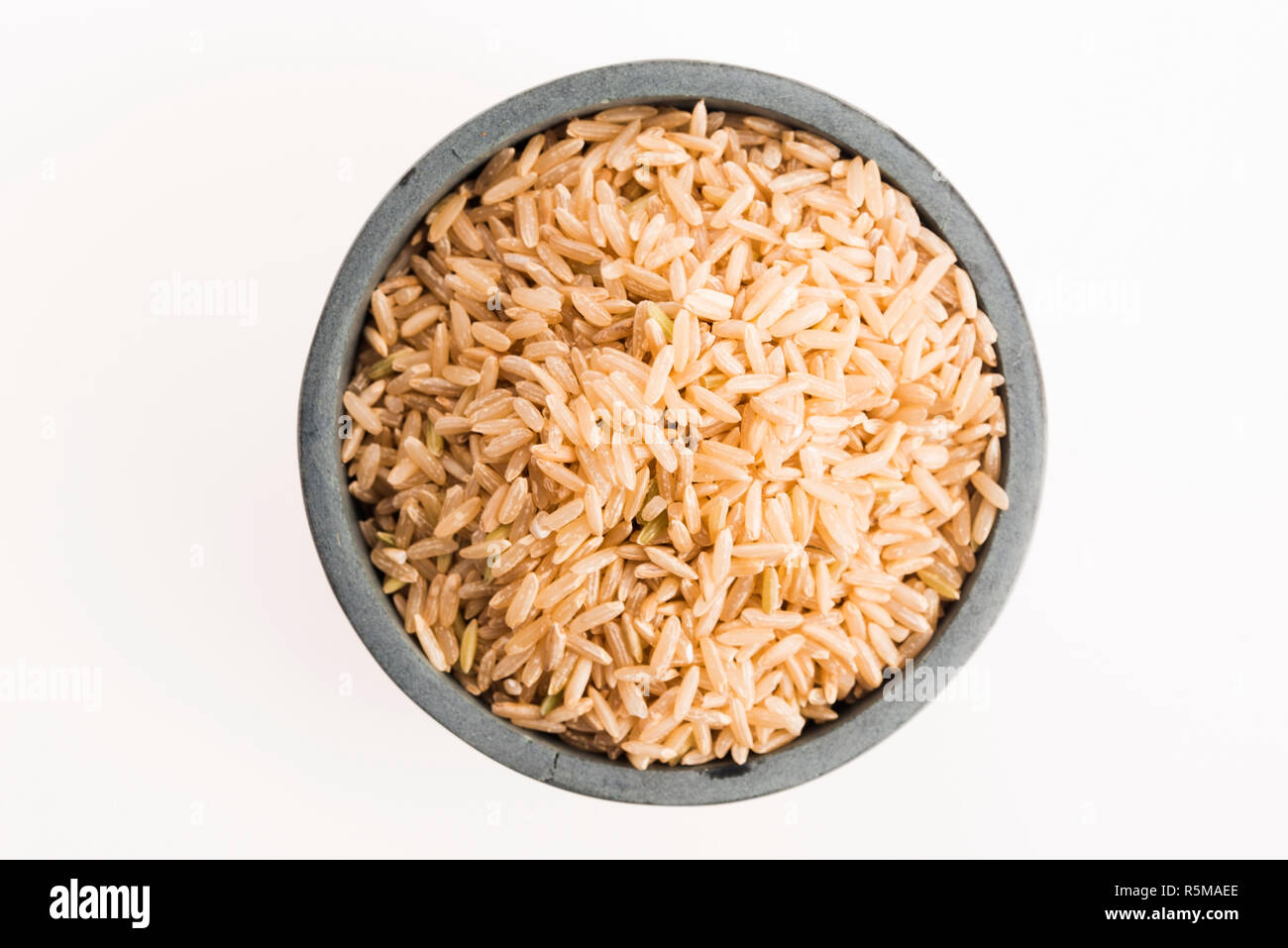 brown rice in a bowl isolated on white background Stock Photo - Alamy