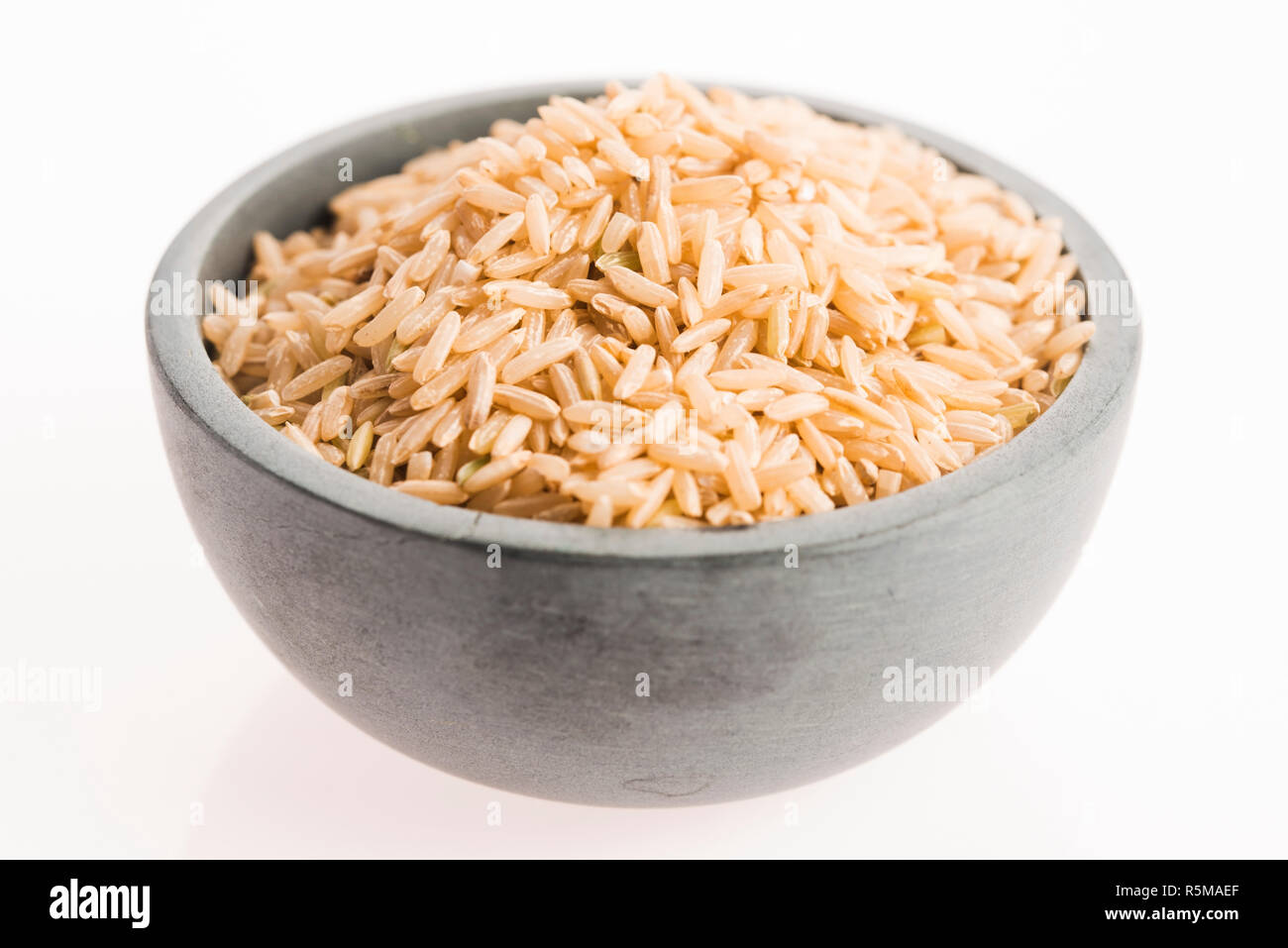 brown rice in a bowl isolated on white background Stock Photo - Alamy