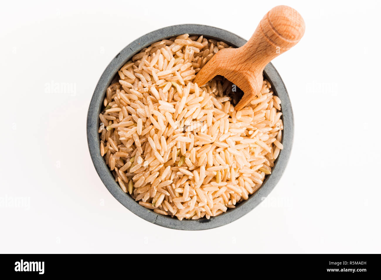 brown rice in a bowl isolated on white background Stock Photo - Alamy
