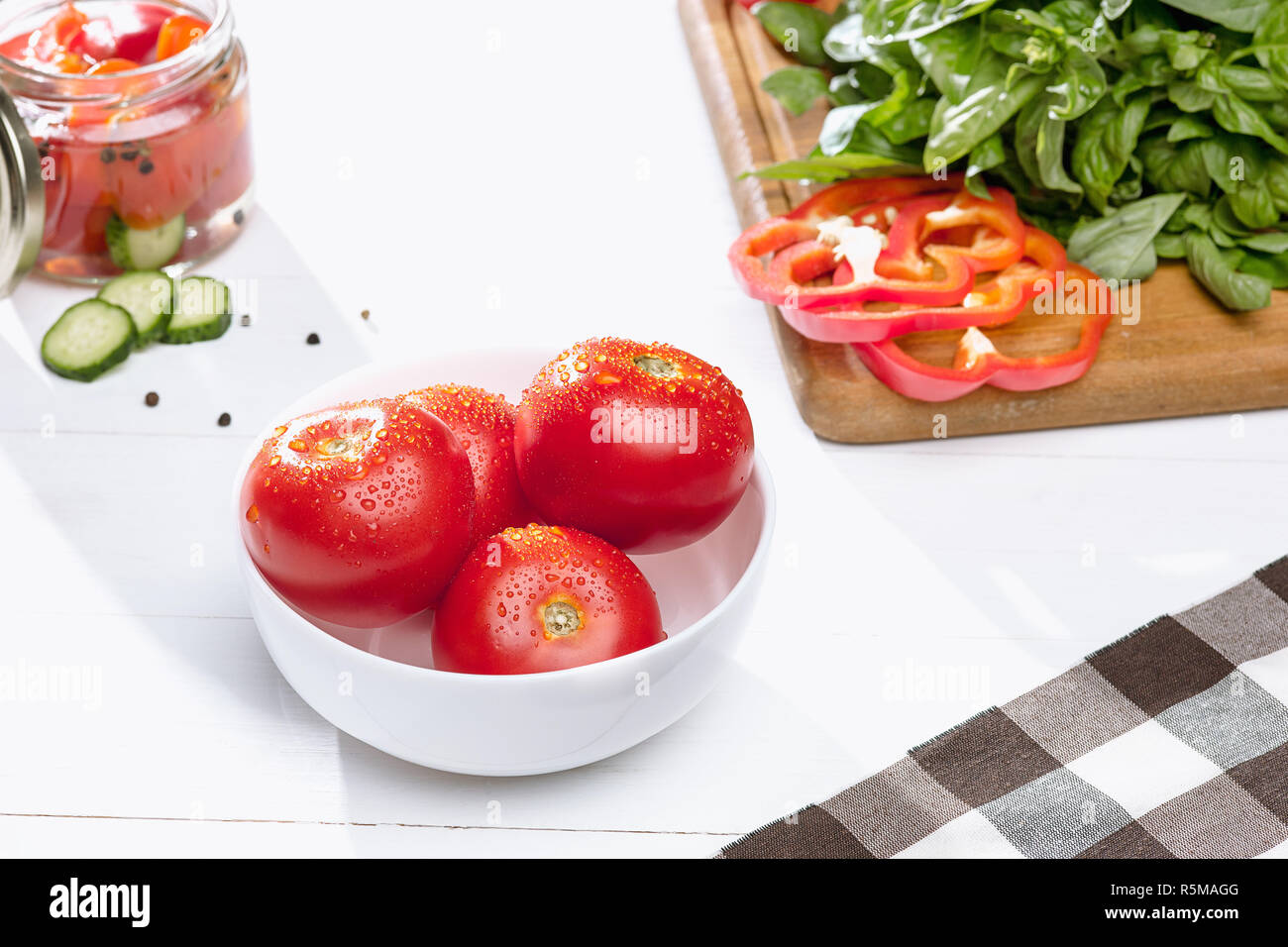 Canned tomatoes and fresh tomato on white background Stock Photo - Alamy