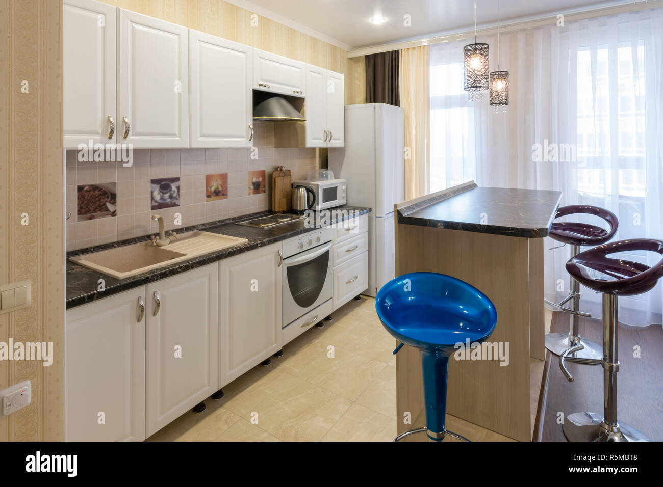 Interior of a one-room apartment, view of a kitchen set and a bar ...