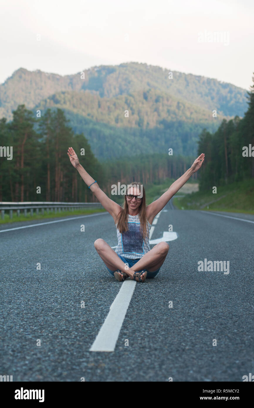 Woman sitting on the road Stock Photo - Alamy