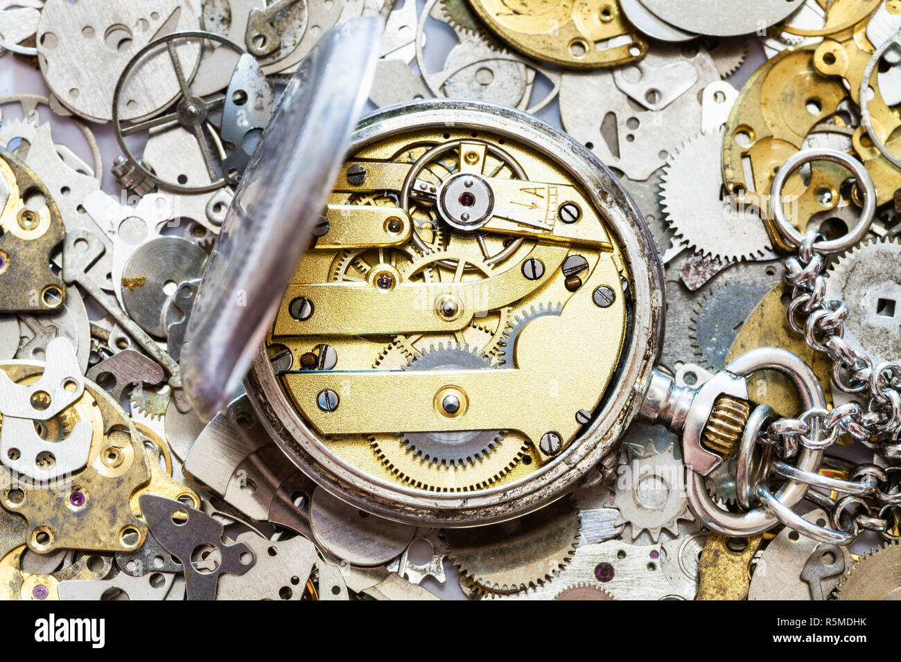 open vintage pocket watch on heap of spare parts Stock Photo - Alamy