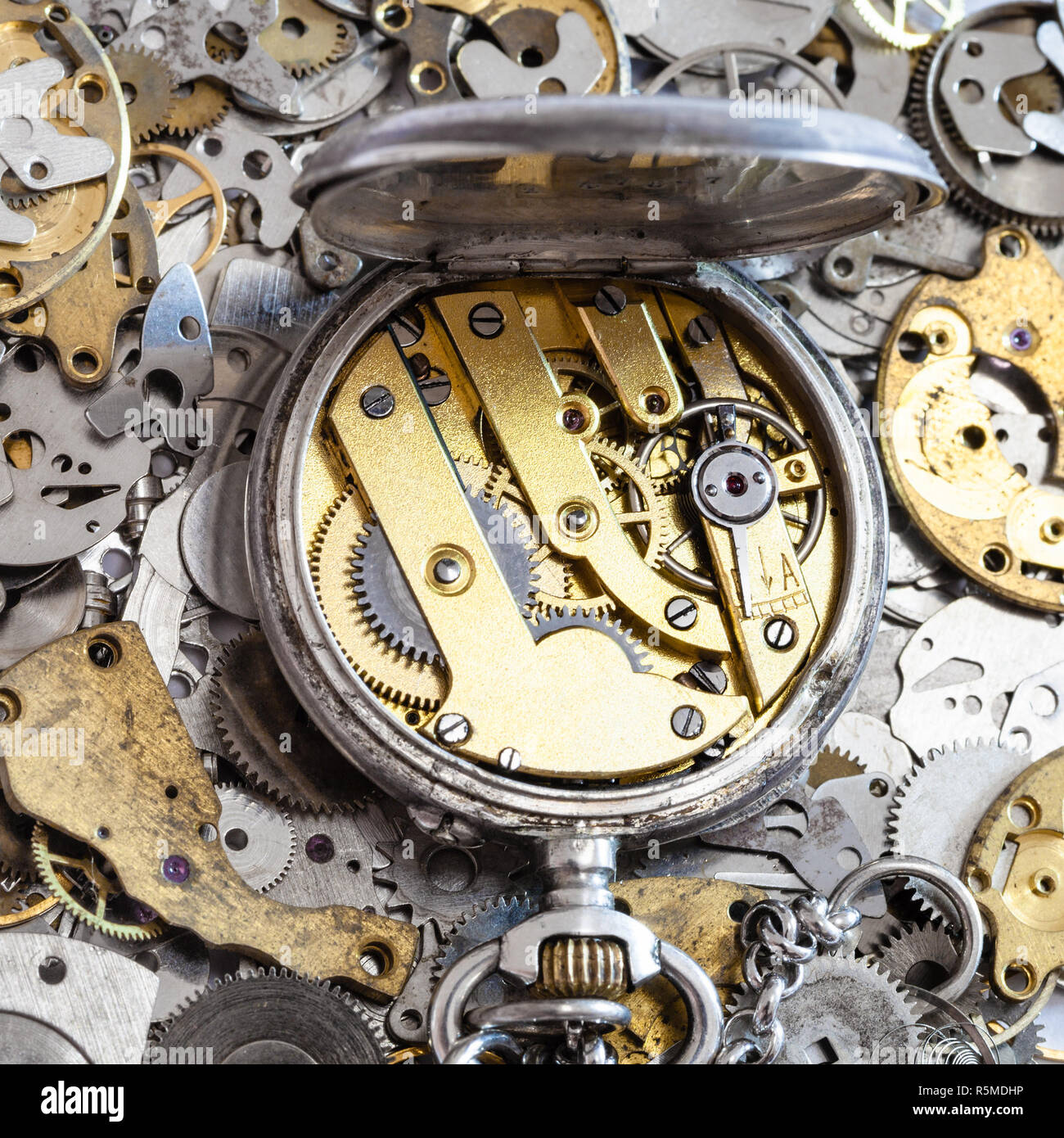 open vintage pocket watch on pile of spare parts Stock Photo - Alamy