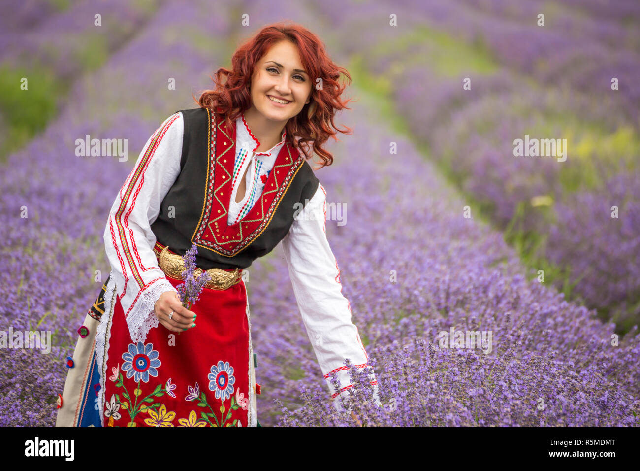 Woman dressed in traditional bulgarian dress called Nosia enjoying a ...
