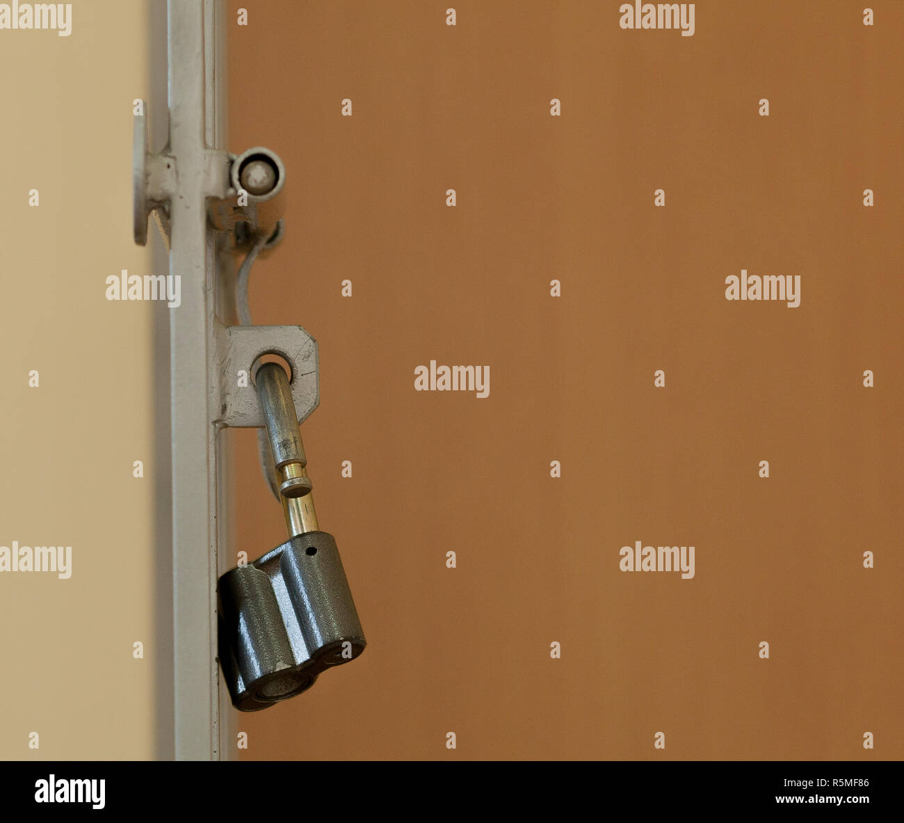 Old open padlock with old steel door Stock Photo - Alamy