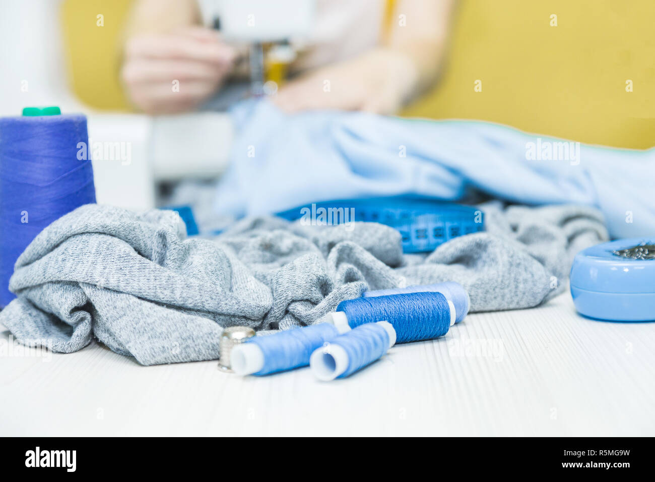 Sewing workshop. Seamstress at work. Young woman working with sewing ...