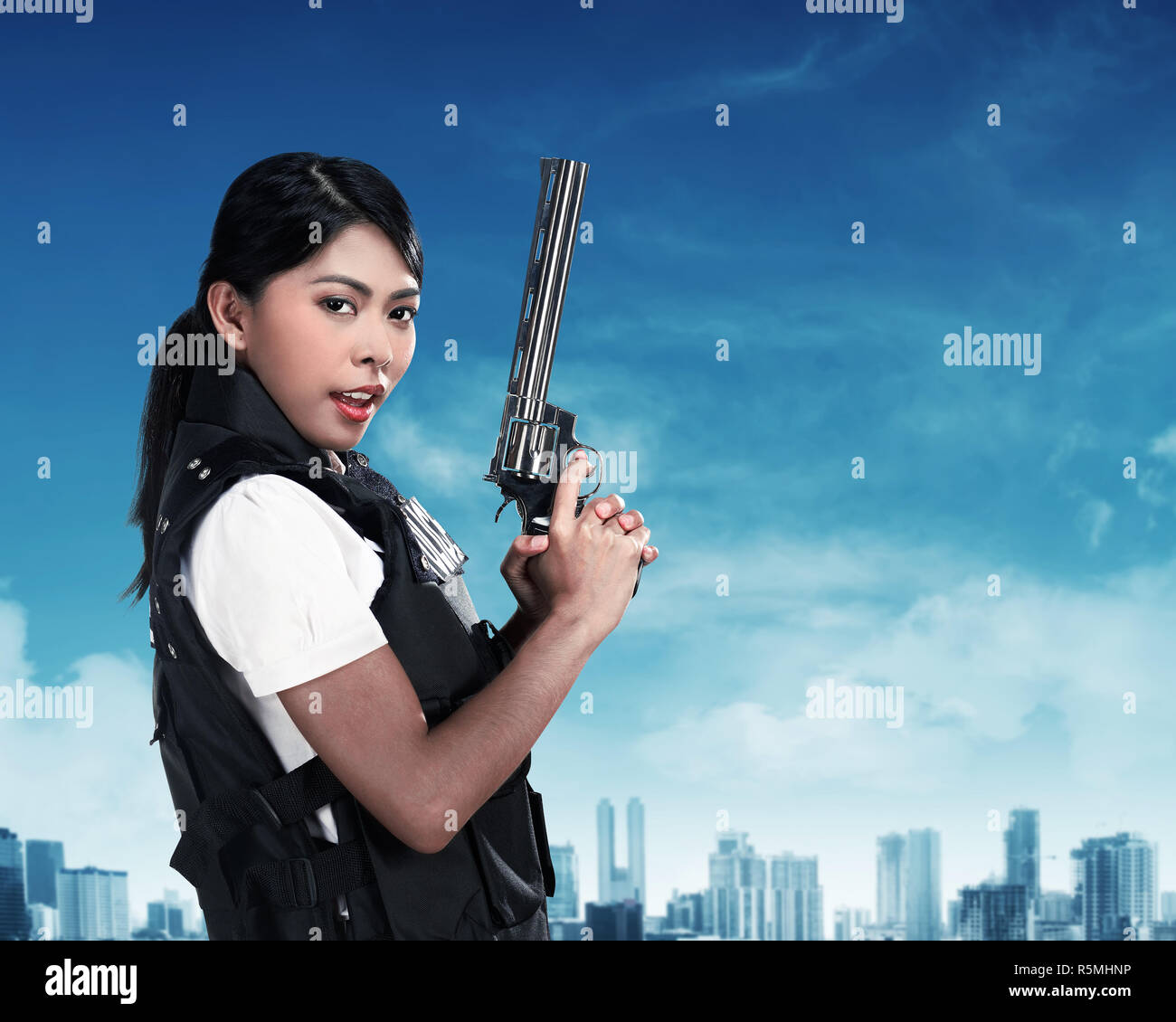 Beautiful police woman holding gun Stock Photo - Alamy