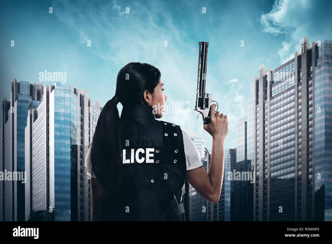 Beautiful police woman holding gun Stock Photo - Alamy