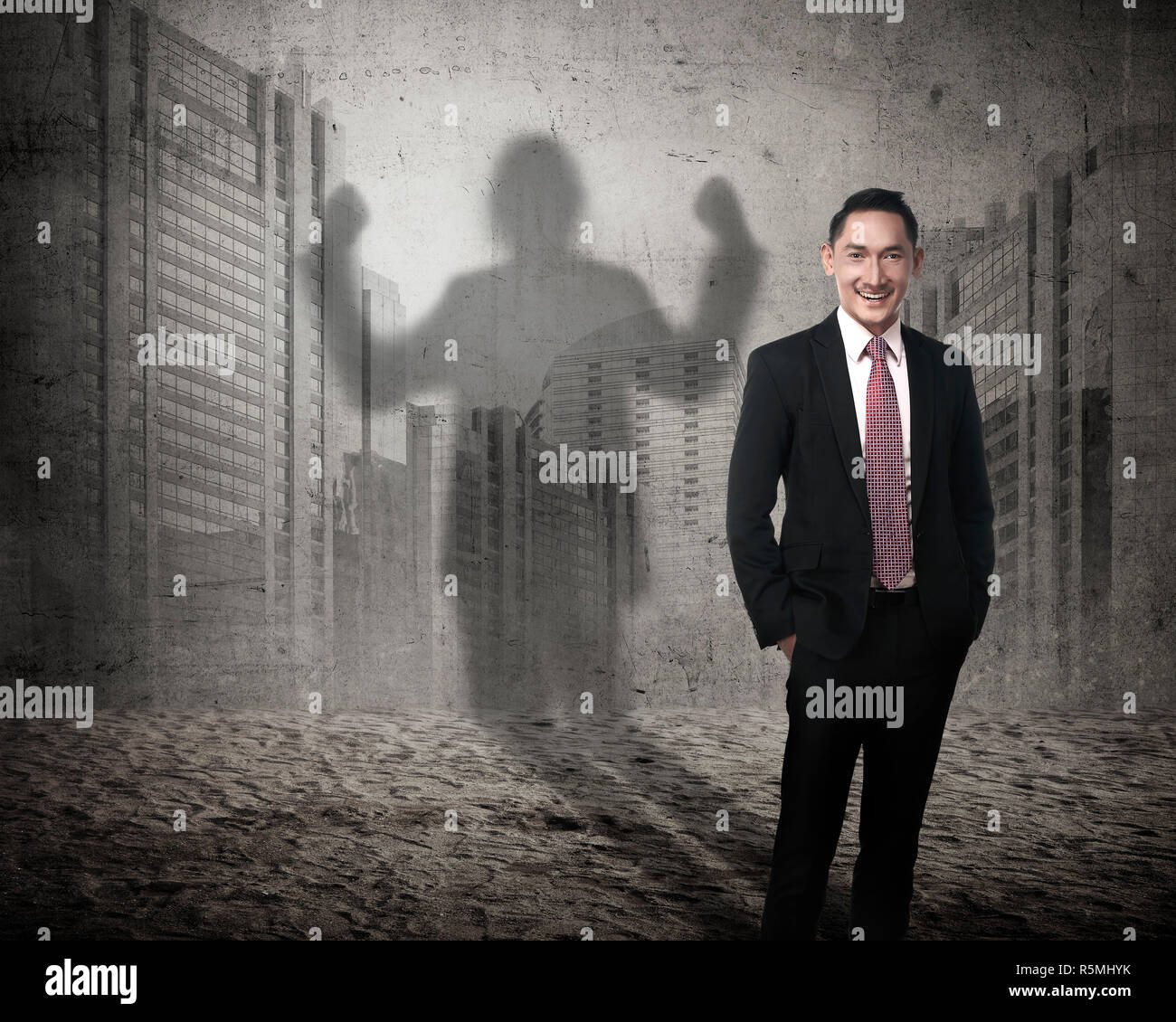 Asian business man casting a shadow of strength Stock Photo - Alamy