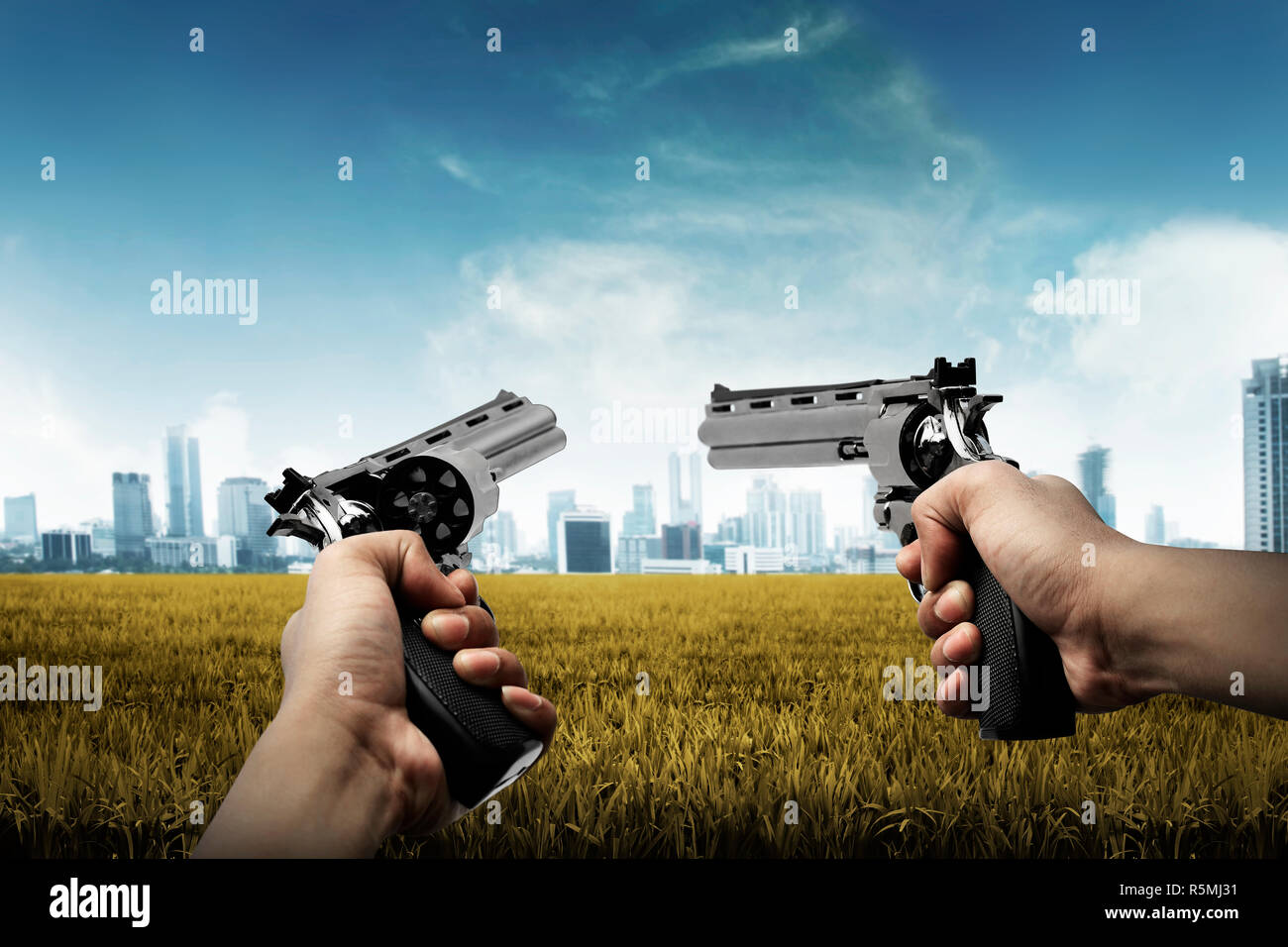 Man hand holding two gun Stock Photo - Alamy