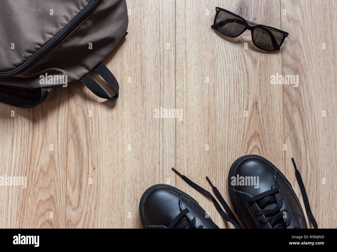 backpack glasses and sneakers on wooden background Stock Photo - Alamy