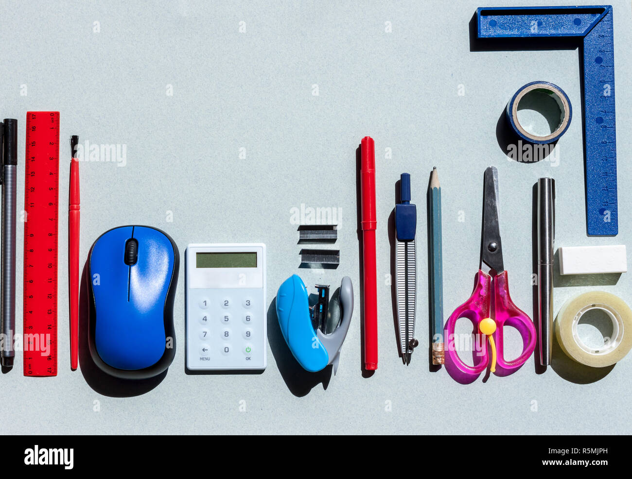 school stationery on blue paper background Stock Photo - Alamy