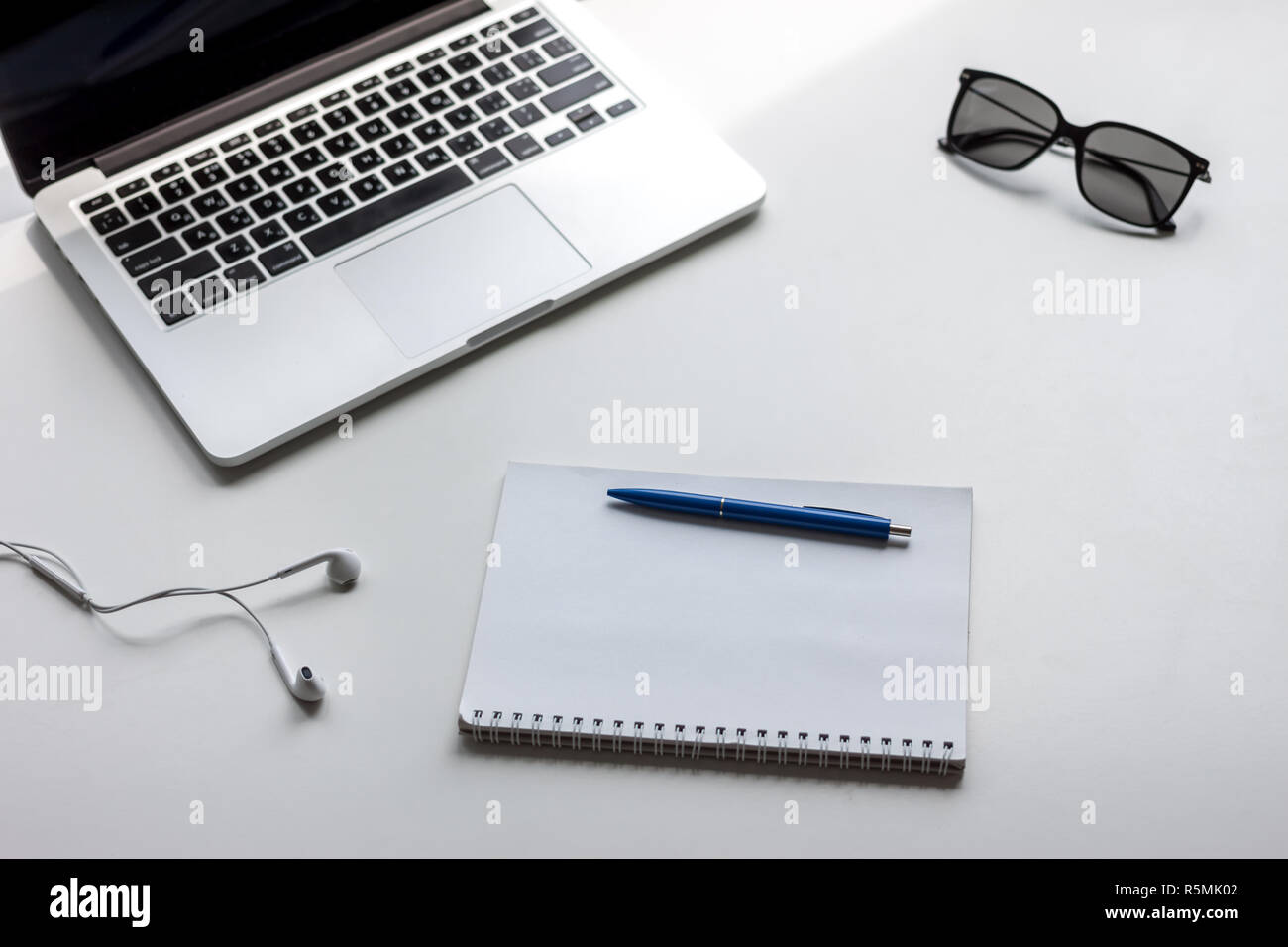 work desk with laptop and notebook Stock Photo - Alamy
