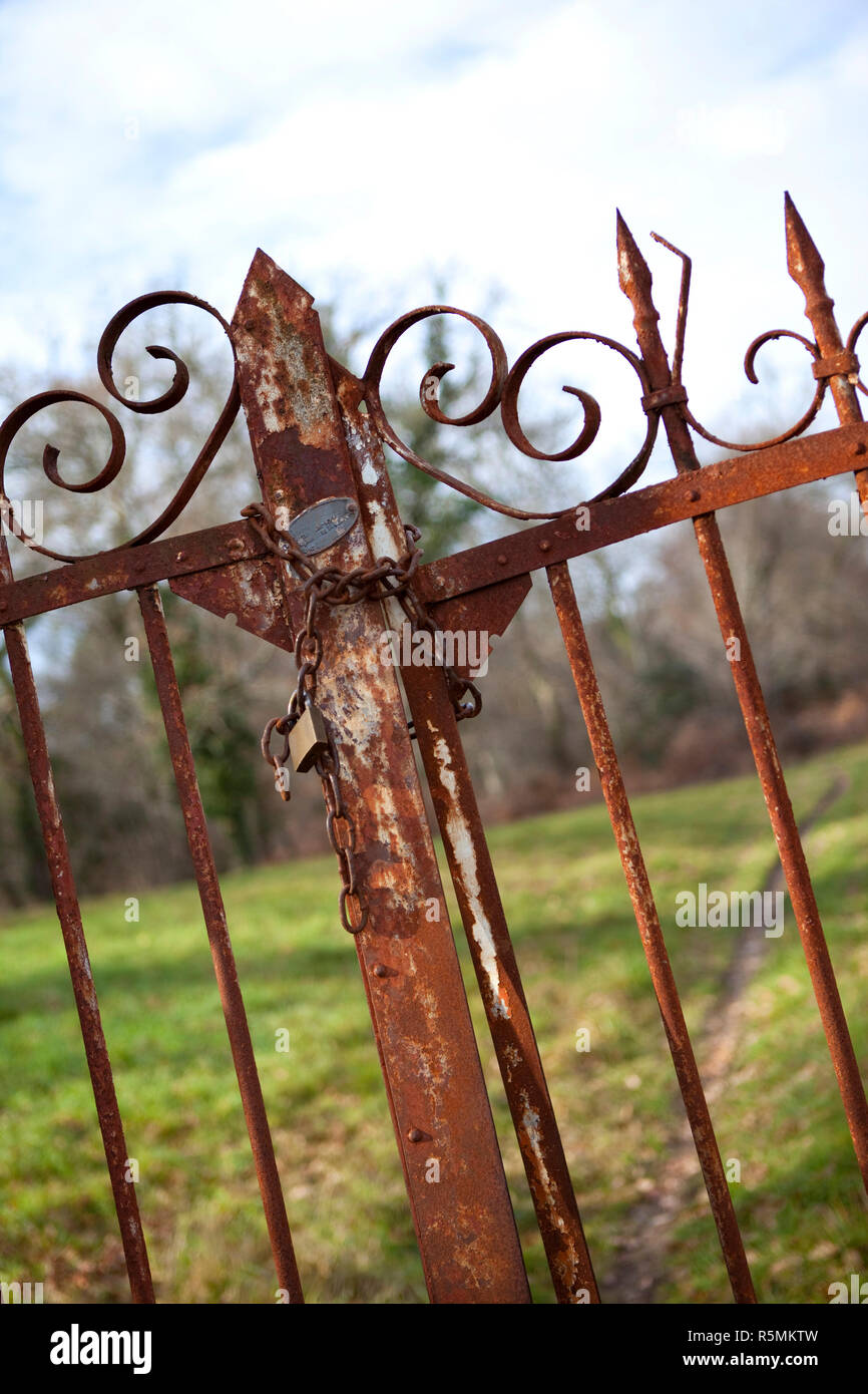 Old rusty gate facing a park in the countryside Stock Photo - Alamy