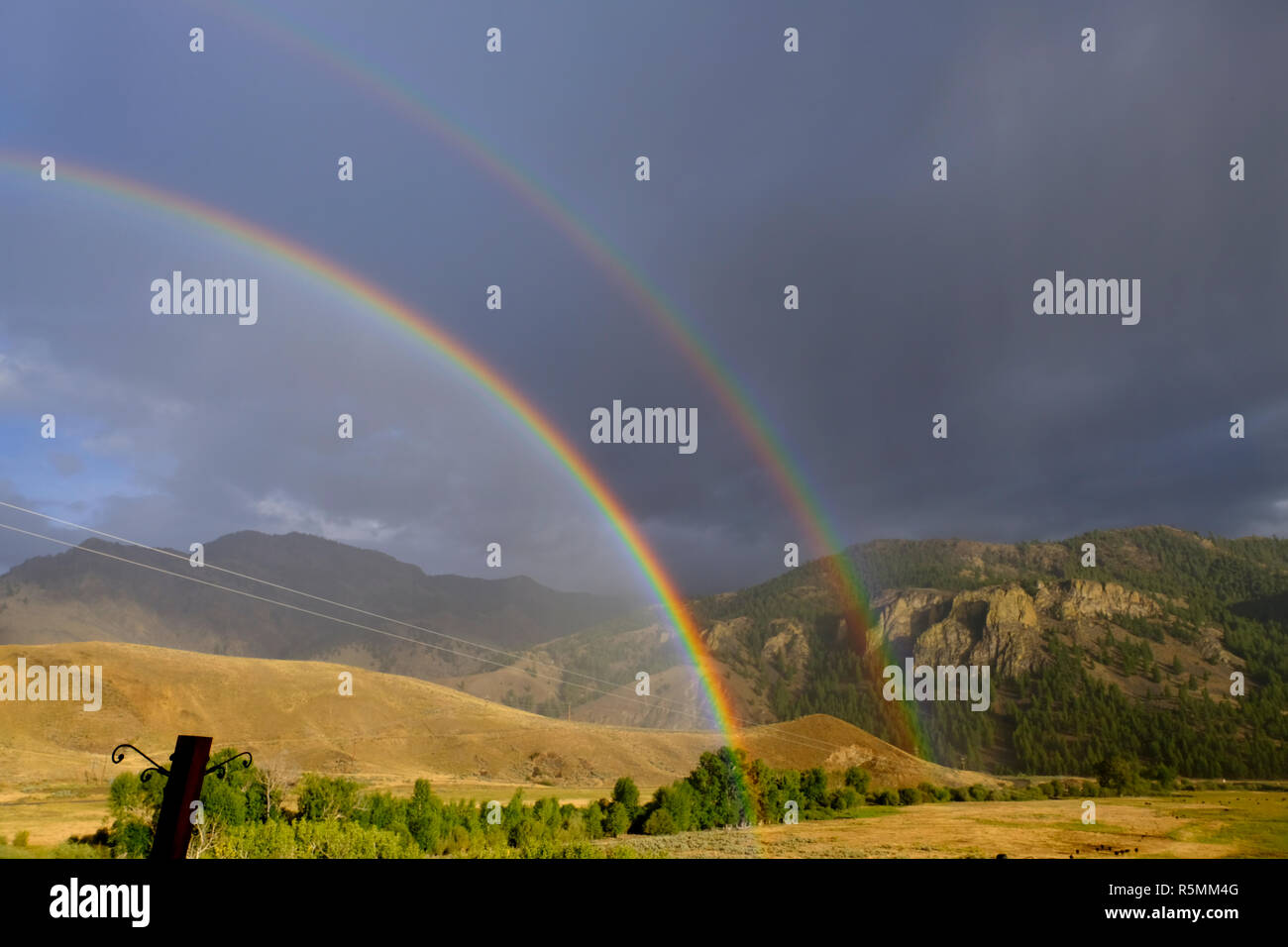Rainbow and double rainbow over the mountains in Central Idaho Stock ...