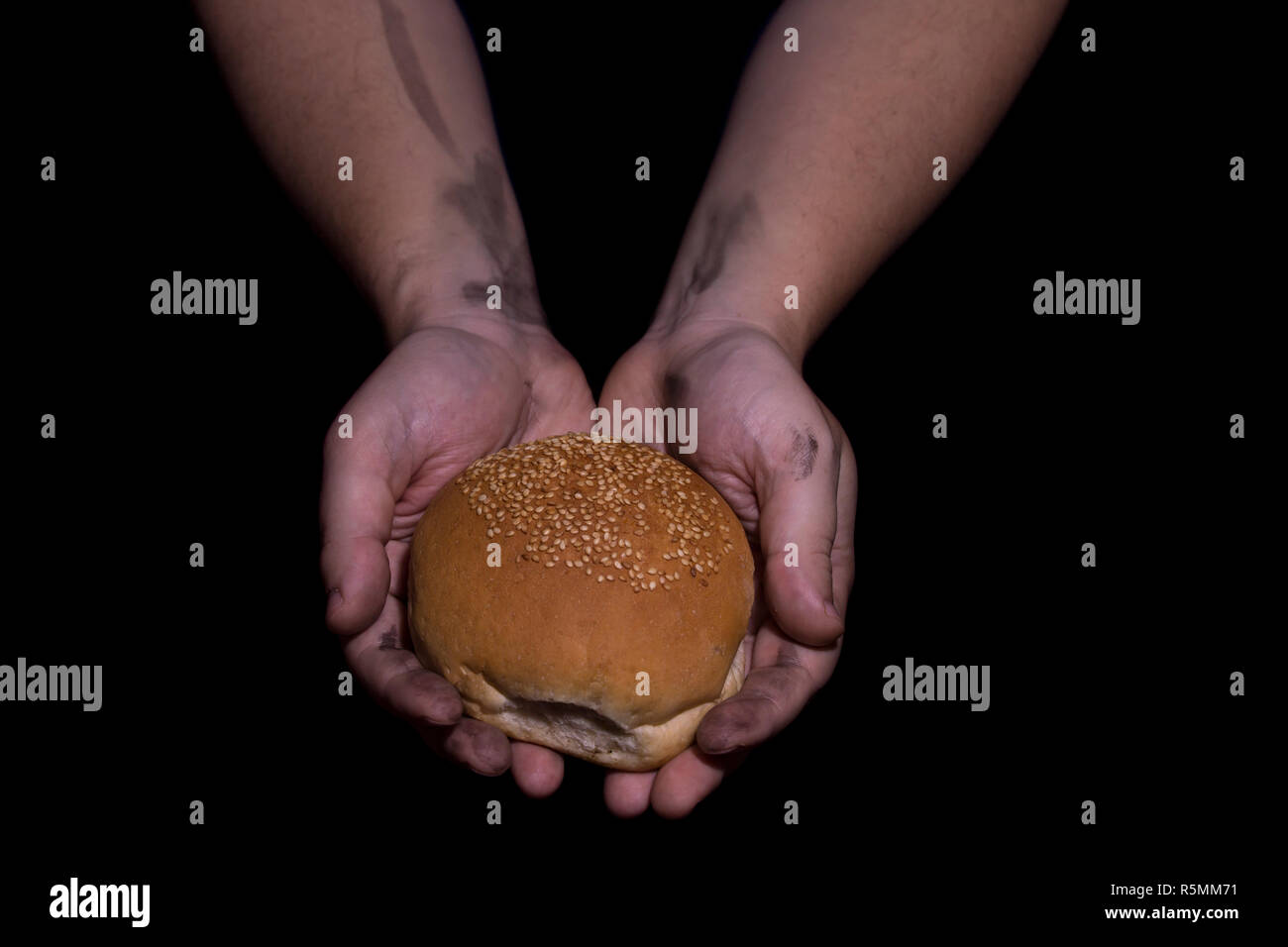 Poverty concept. Hands holding bread isolated on balck background Stock ...