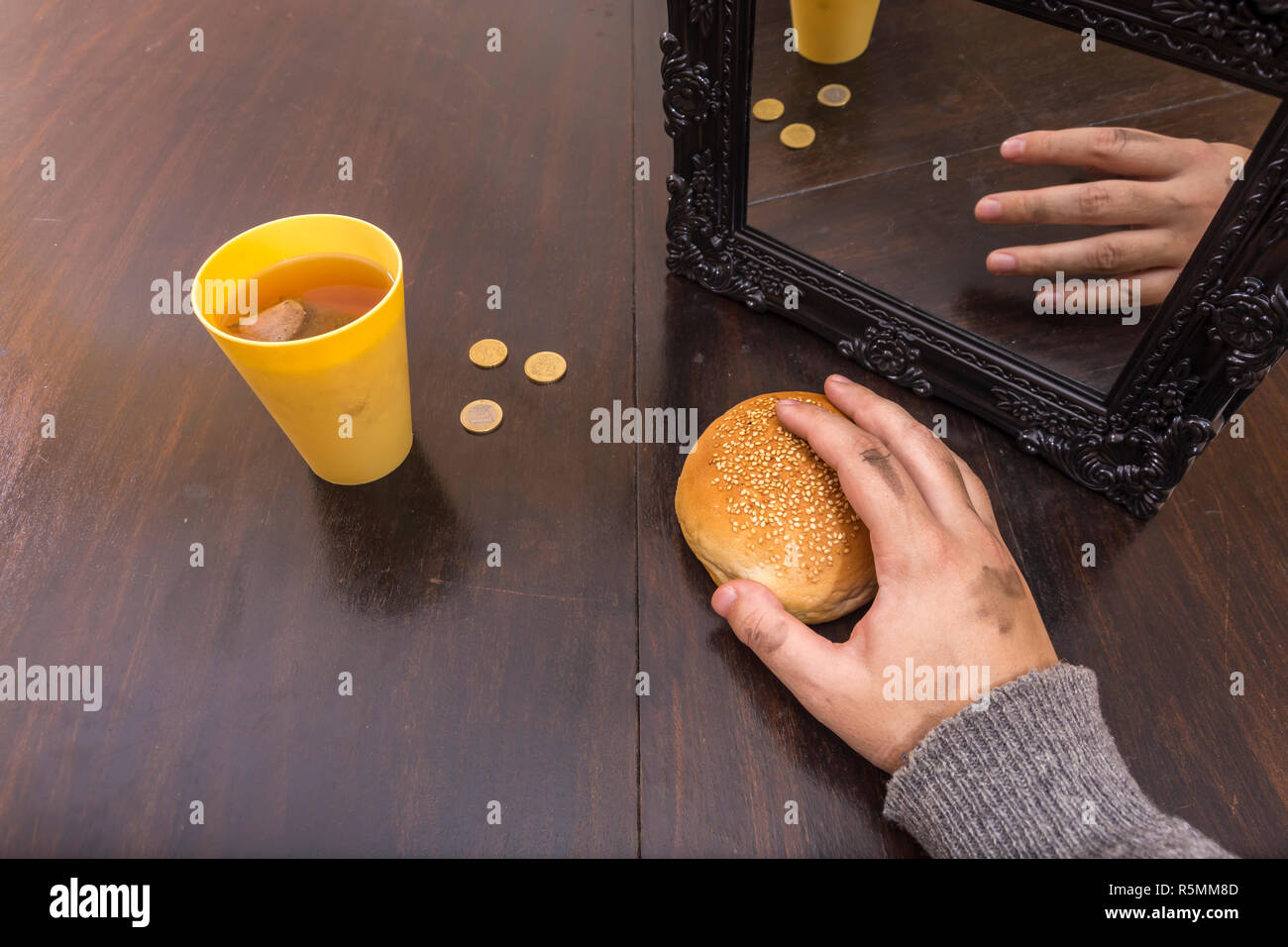 Human hand taking bread from a worn out table. Poverty concept. No ...