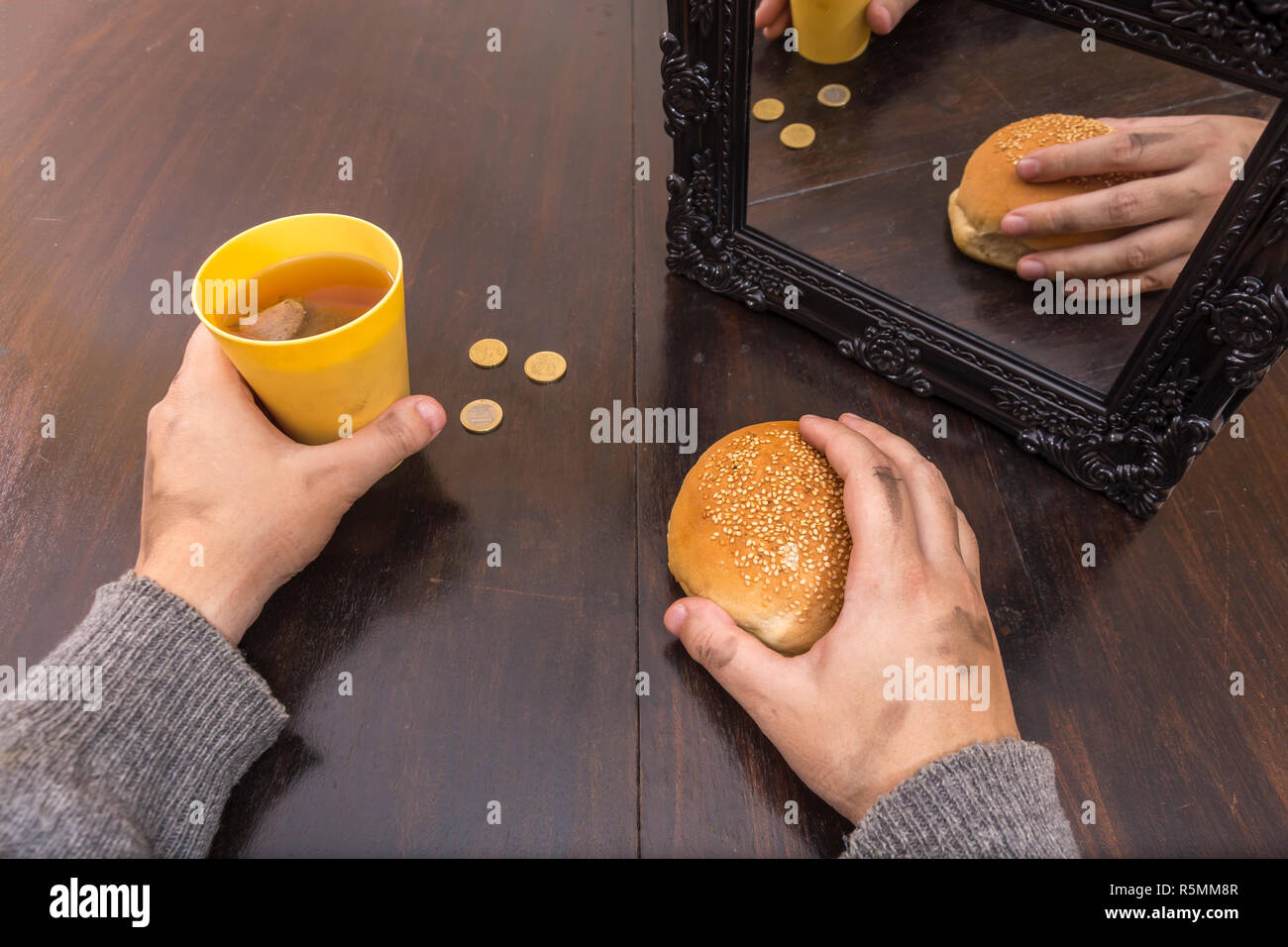 Human hand taking bread from a worn out table. Poverty concept. No ...