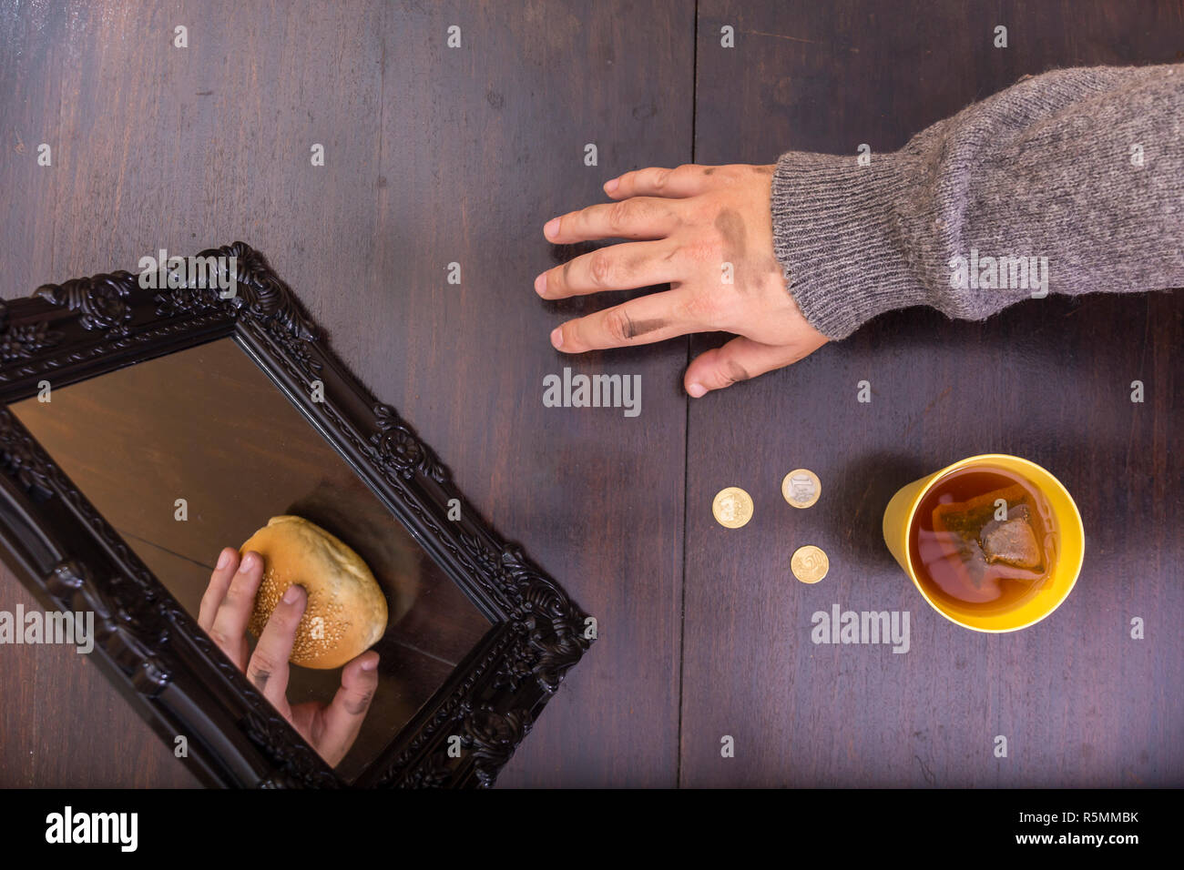 Human hand taking bread from a worn out table. Poverty concept. No ...