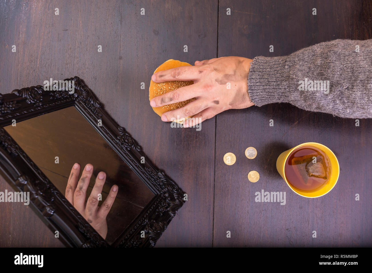 Human hand taking bread from a worn out table. Poverty concept. No ...