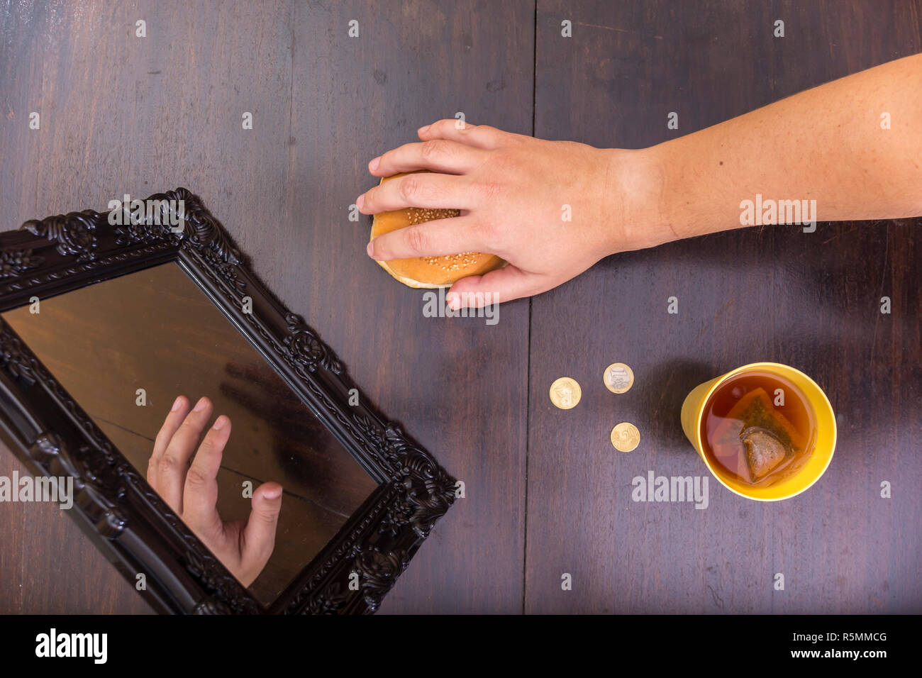 Human hand taking bread from a worn out table. Poverty concept. No ...
