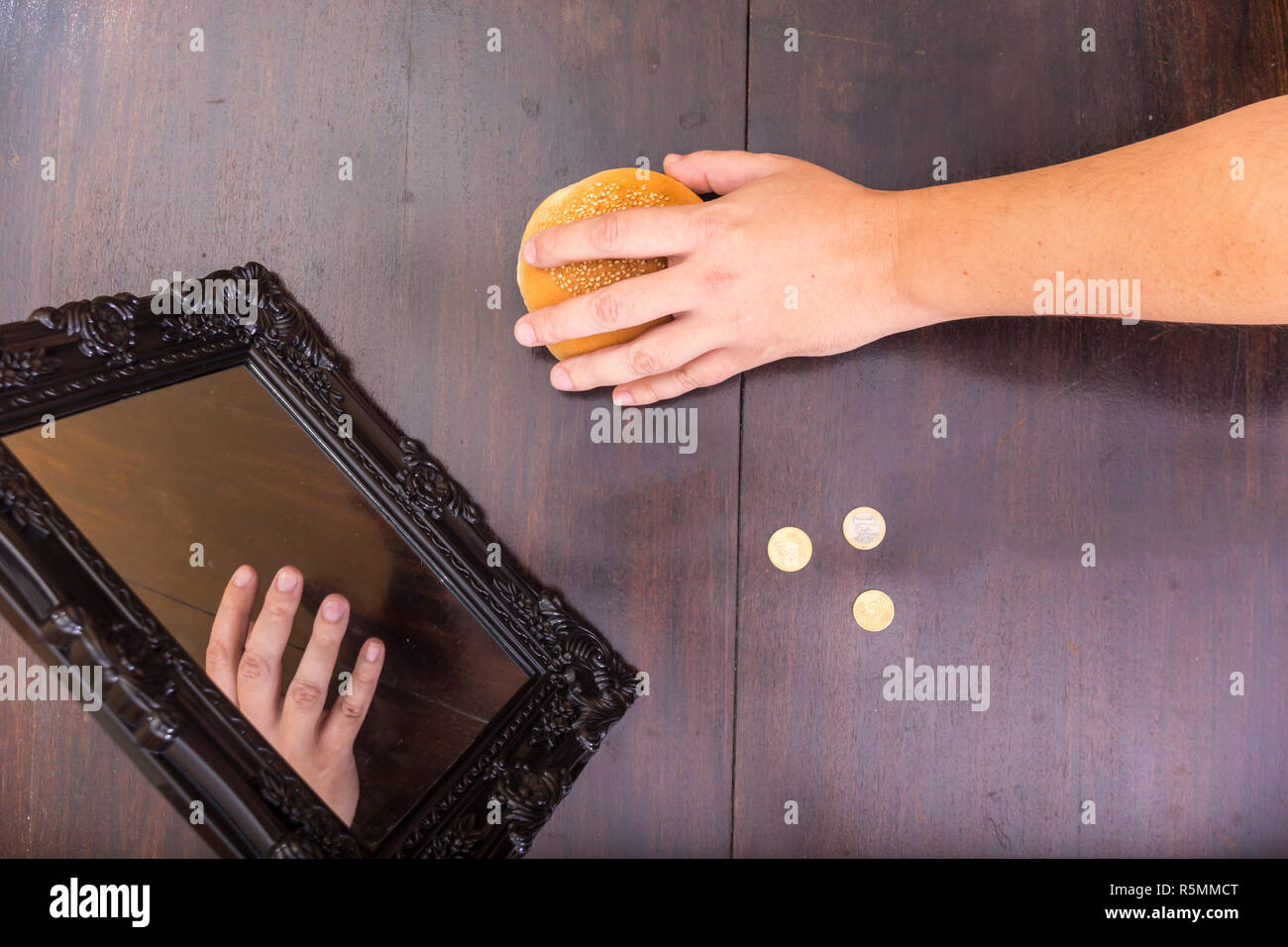 Human hand taking bread from a worn out table. Poverty concept. No ...