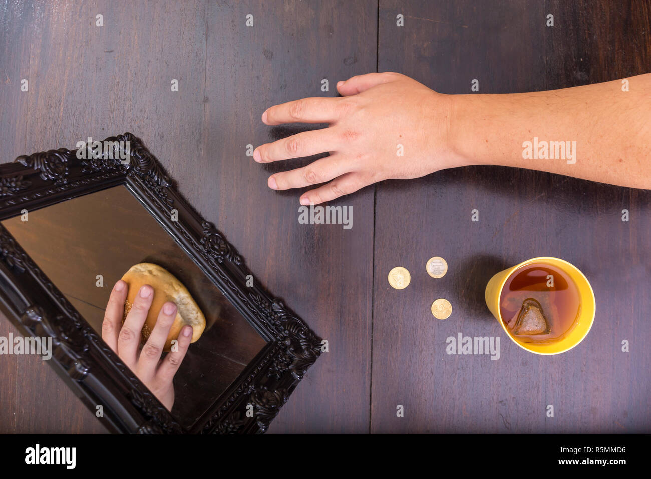 Human hand taking bread from a worn out table. Poverty concept. No ...