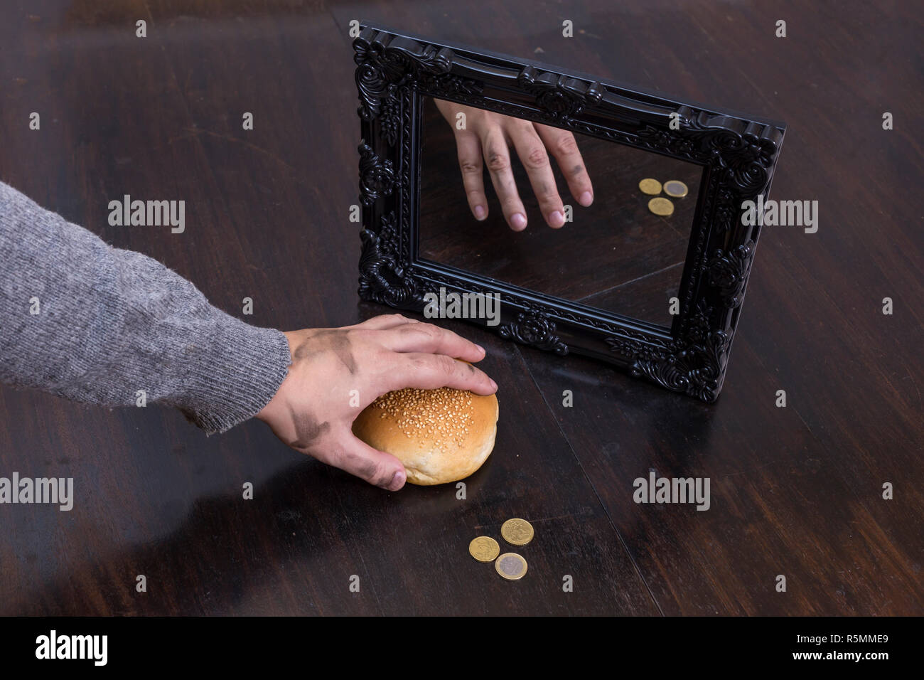 Human hand taking bread from a worn out table. Poverty concept. No ...
