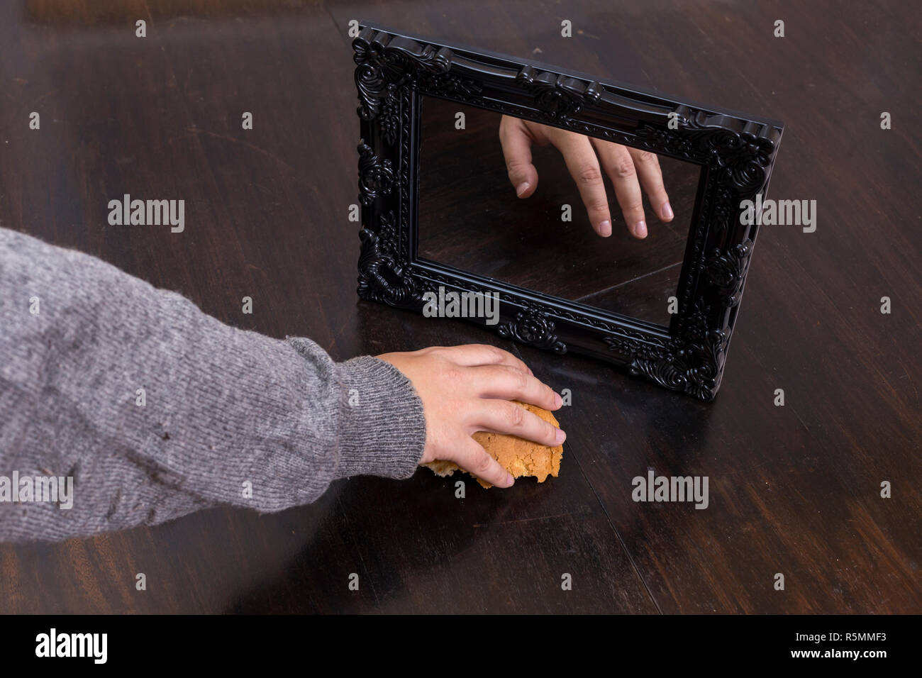 Human hand taking bread from a worn out table. Poverty concept. No ...