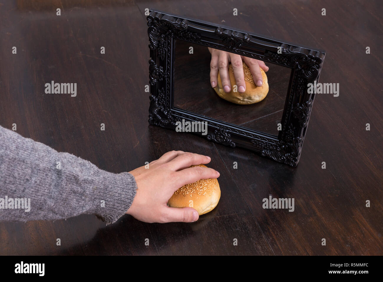 Human hand taking bread from a worn out table. Poverty concept. No ...