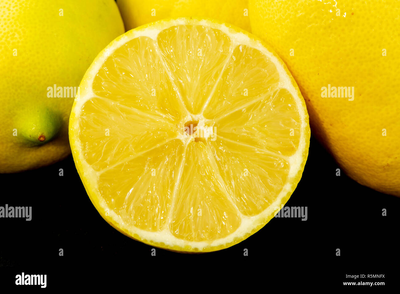Fresh sliced and whole lemons with isolated black background Stock ...