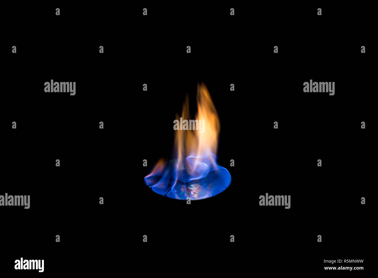 CD burning with a colorfull blue flame isolated on black background ...