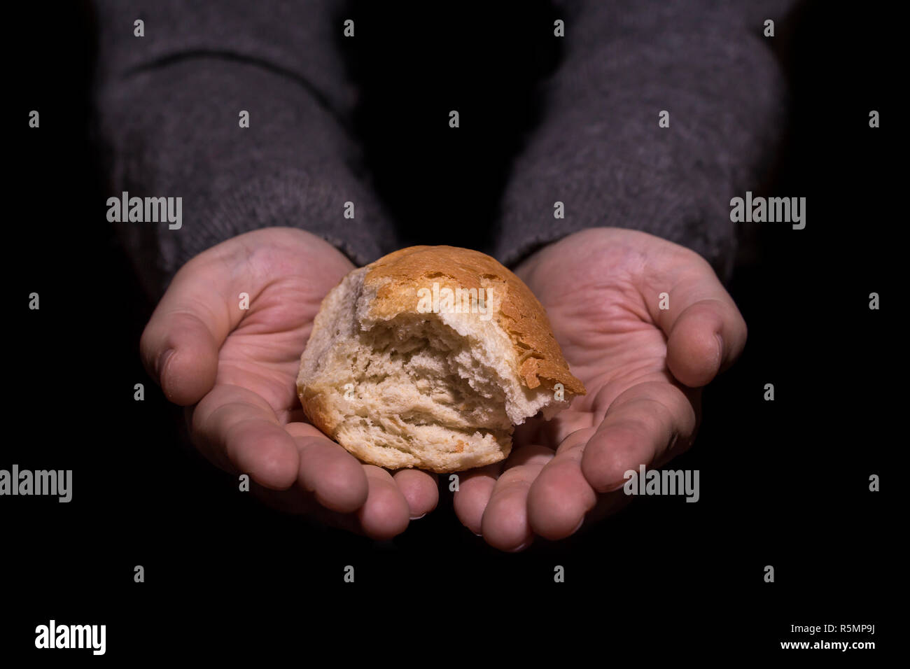 Poverty concept. Hands giving bread isolated on balck background Stock ...