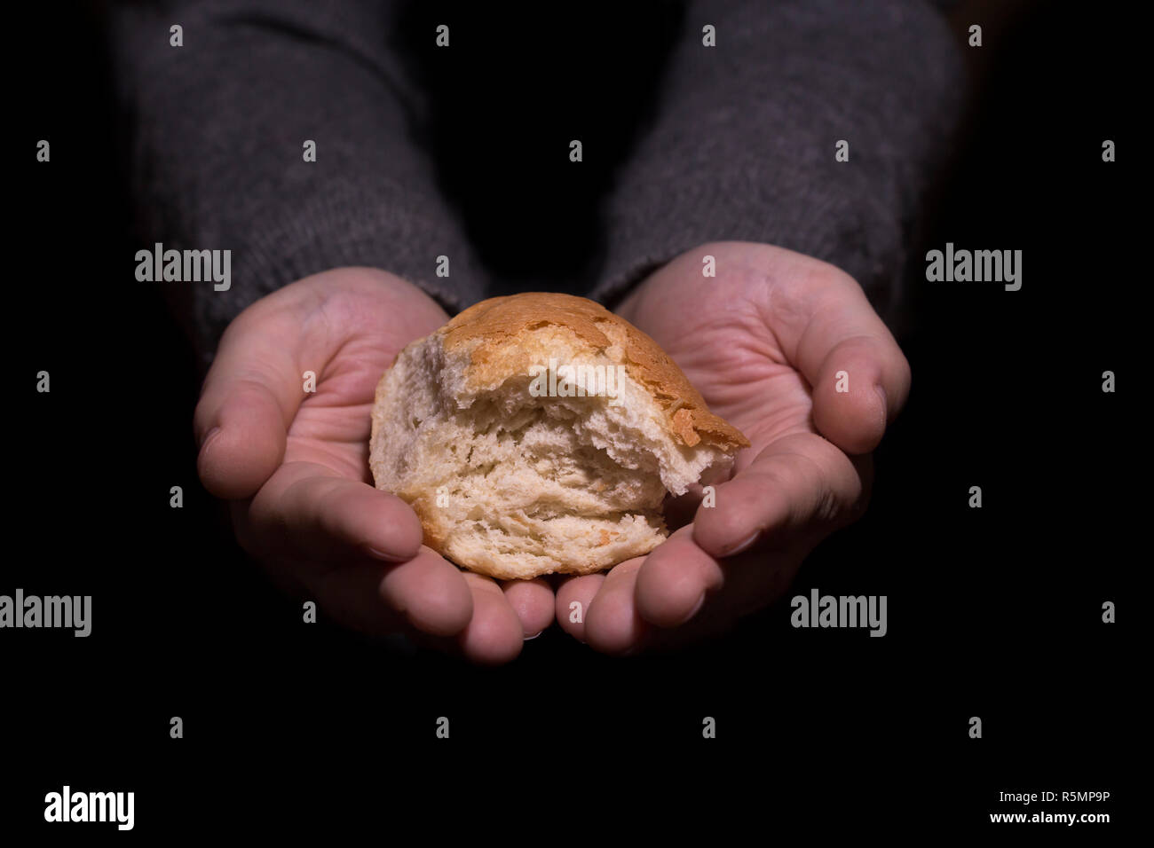 Poverty concept. Hands giving bread isolated on balck background Stock ...