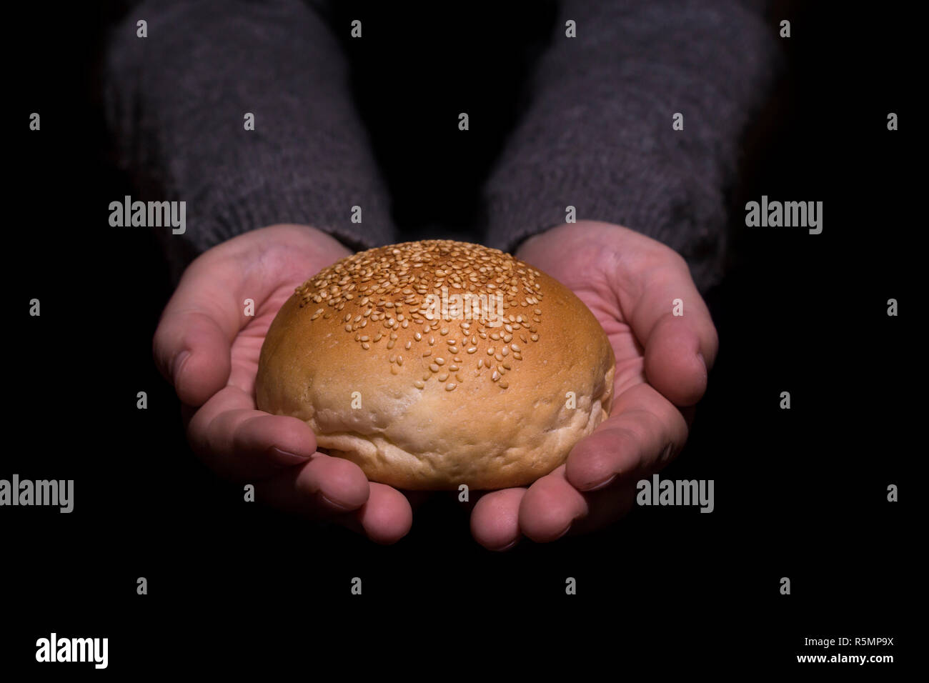 Poverty concept. Hands giving bread isolated on balck background Stock ...