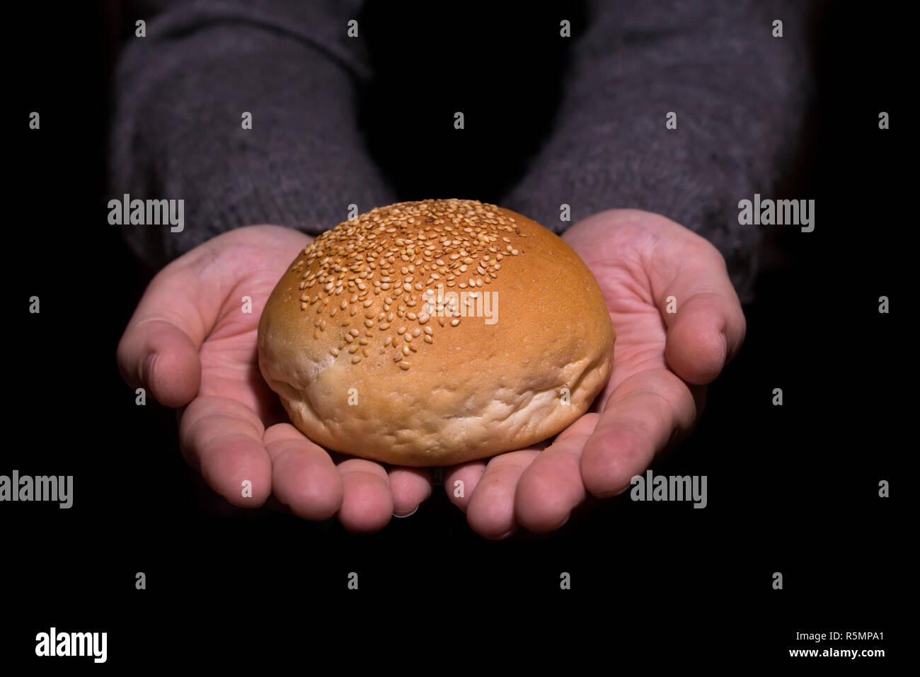 Poverty concept. Hands giving bread isolated on balck background Stock ...