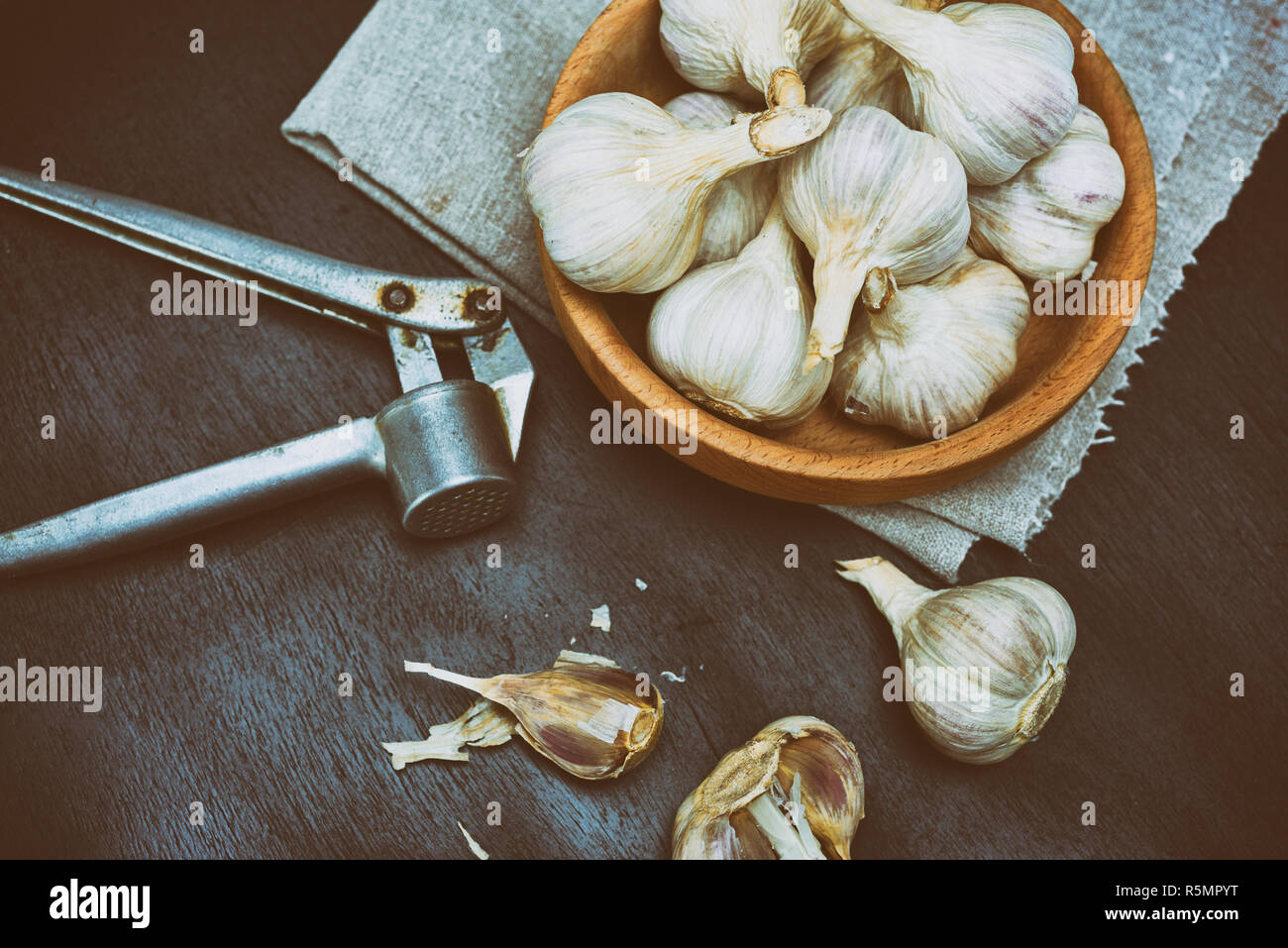Harvest garlic in husk in a wooden bowl Stock Photo - Alamy