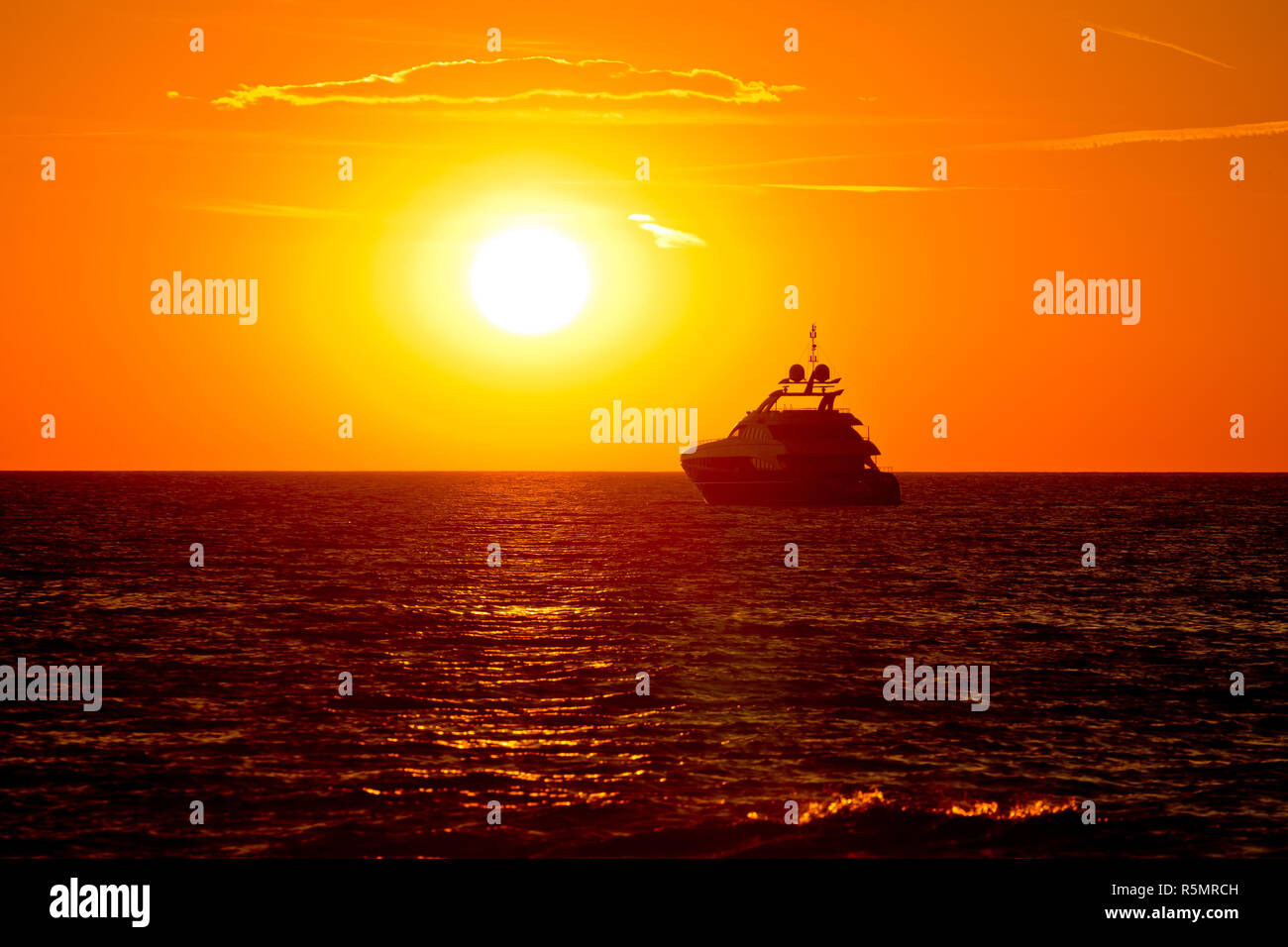 Luxury yacht on open sea at golden sunset Stock Photo - Alamy